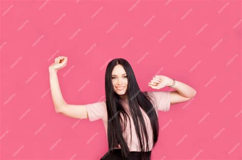 Premium Photo Brunette Girl Dancing On A Pink Wall