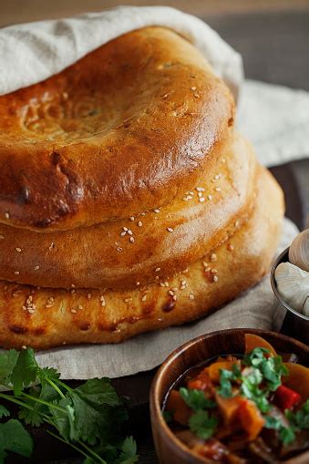 일반적인 전통적인 우즈베크어 라운드 모양 Tandoor 빵 나무 배경에 구운 국가 아시아 식사 음식 빵 0명에 대한 스톡 사진