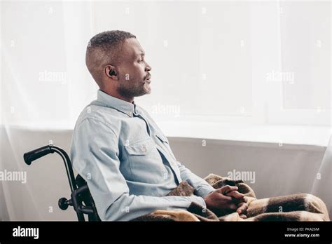 Side View Of Senior African American Man Sitting In Wheelchair And