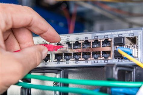 Hand Of Engineer Plugging In Ethernet Cable Into Server Switch P Stock