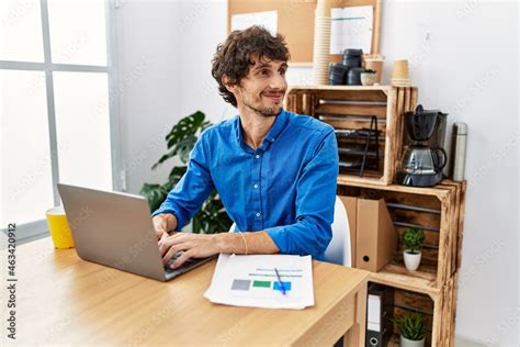 Young Hispanic Man With Beard Working At The Office Using Computer