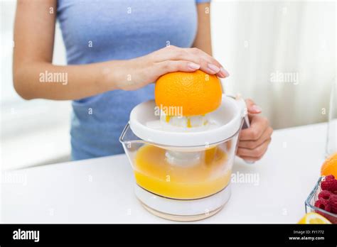 close up of woman squeezing orange juice at home Stock Photo - Alamy