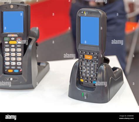 Handheld Computer Barcode Scanner Device At Charging Station Dock Stock