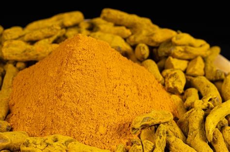 Premium Photo Turmeric Powder And Dried Turmeric Root On A Black
