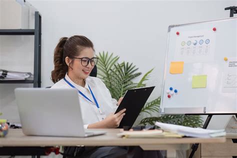 Beautiful Determined Business Woman Working Using Laptop Recording Data