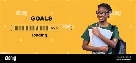 Black Female Student With Notebooks And Backpack Pointing Aside At GOALS Loading Progress Bar On