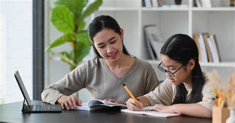 집에서 숙제로 딸을 돕는 젊은 어머니 사진 Unsplash의 교육 이미지