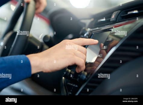 Selective Focus Of Unrecognizable Man Touching Sensor Display In Car Close Up Of Using Control
