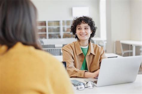 Premium Photo Two Women In Library Or Coworking Are Sitting Opposite