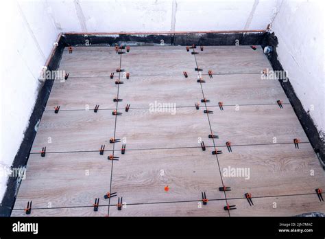 Close Up Of The Tile Alignment System Holding Tile In Given Position Stock Photo Alamy