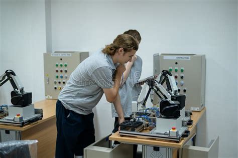 Trainee Robotics Engineer Learning With Programming And Manipulating Robot Hand Industrial