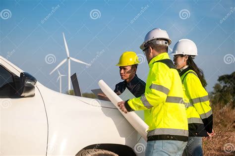 Engineers Brainstorm On A Plan To Inspect The Performance Of Wind Turbines In The Field Stock