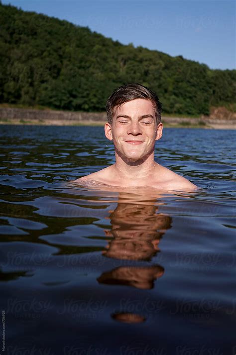 Young Man In A Lake By Stocksy Contributor Marcel Stocksy