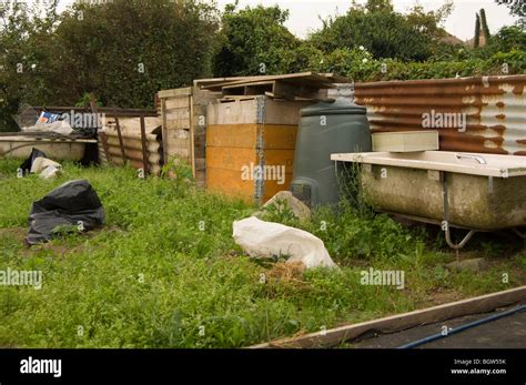 Composting Area Of An Allotment Plot Showing Various Compost Bins And Old Household Baths Being