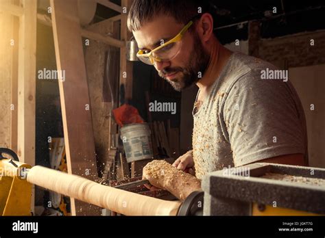 A Young Man Builder Wearing Safety Goggles With A Beard And A Gray T