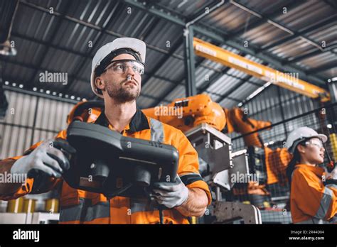 engineer team working with robot welding in automation factory people