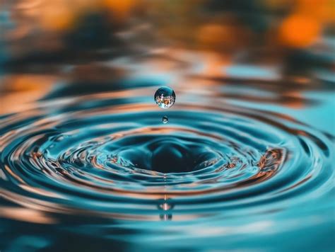 Water Drop Breaking The Surface Tension Symbolizing Disruption