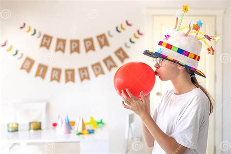 A Festive Girl Inflates A Balloon On Her Birthday Birthday Concept