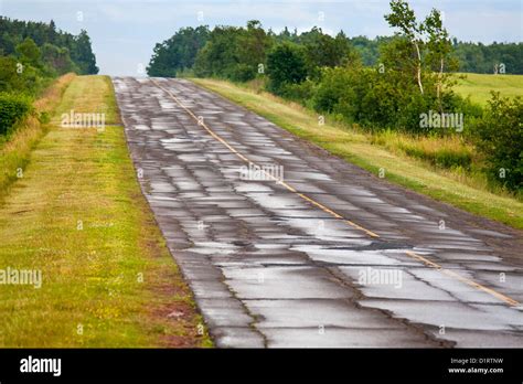 A Paved Asphalt Road Broken Up From Freezing And Thawing Cold Patch Is