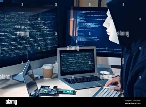 Masked Man Hacking Server In Dark Room Stock Photo Alamy