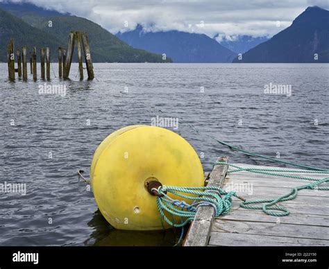 a large bright yellow anchor buoy tied to a float with heavy green rope