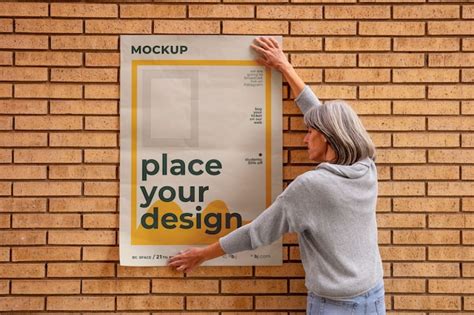 Premium Psd View Of Person Sticking Exterior Poster Mock Up On Wall