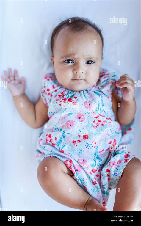 Portrait Of Baby Girl Lying On Bed Hi Res Stock Photography And Images