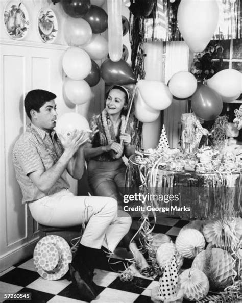 2 Young Women And Man Blowing Balloons Photos And Premium High Res