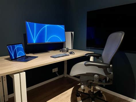 A Computer Desk With A Laptop On It And A Monitor Sitting On Top Of It