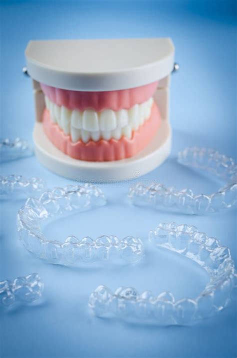 Invisible Dental Teeth Brackets Tooth Aligners On Blue Background