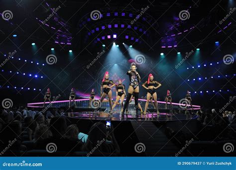 Olya Polyakova And Her Band Singing And Dancing On Stage During Concert
