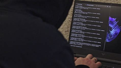 Slow Motion Footage Of The Man Looked Like Hacker In A Hood Sitting In The Front Of Laptop