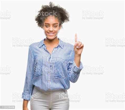격리 된 배경에 보여주는 고 자신감과 행복 미소 하면서 1 번 손가락으로 가리키는 젊은 아프리카 미국 여자 가리키기에 대한 스톡 사진 및 기타 이미지 Istock