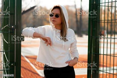 야외 선글라스에 긴 머리를 가진 젊은 아름다운 여자의 초상화를 닫습니다 흰색 스웨터를 입고 스포츠 그라운드 근처 야외에 대한 스톡 사진 및 기타 이미지 Istock