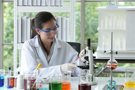 Premium Photo Female Scientist Using Microscope At Laboratory