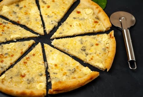 Premium Photo Four Cheese Pizza With Different Types Of Cheese On A