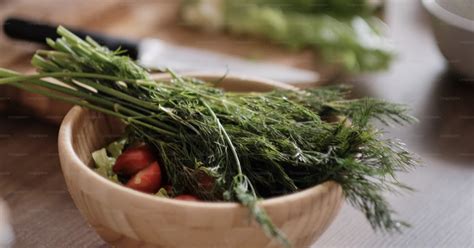 부엌에서 녹색 상추를 자르는 남자의 손을 닫고 나무 테이블에 샐러드를 만든다 사진 Unsplash의 딜 이미지