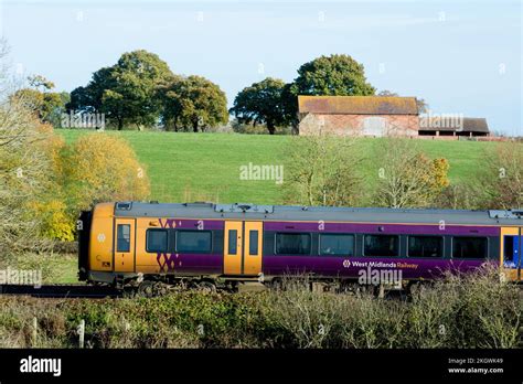 West Midlands Railway Class 170 Diesel Train Side View In Autumn