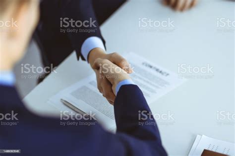 회의 나 협상 클로즈업에서 책상에 앉아있는 동안 비즈니스 사람들은 악수를 현대 사무실에서 알 수없는 사업가의 그룹 팀워크 파트너십 및 악수 컨셉 개념에 대한 스톡 사진 및