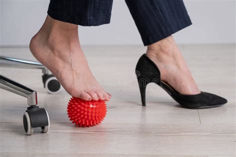Business Woman Massages Her Feet On A Massage Ball With Spikes Stock Photo Image Of Physical