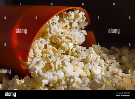 Orange Silicon Bucket Filled With Homemade Cooked Popcorn Inside A Microwave Oven Special