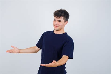 Free Photo Portrait Of Brunette Man Making Asking Question Gesture In Dark T Shirt And Looking
