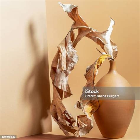 인테리어 홈 디자인의 세부 사항 갈색 배경에 키가 큰 점토 꽃병에 마른 야자수 잎 현대 가정 장식 텍스트 또는 더 많은 목적을위한 공간을 복사합니다 0명에 대한 스톡 사진