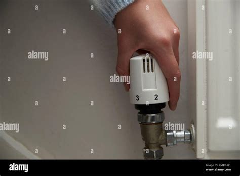 Hand Of Girl Adjusting Radiator Thermostat Regulator At Home Stock Photo Alamy