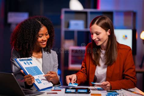 Two Female Ui Ux Designers Work Together To Talk About Designing Mobile App Interfaces On Both