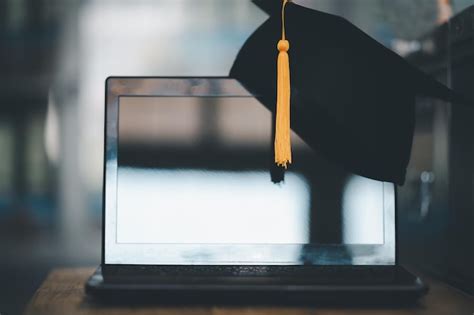 Premium Photo Graduation Cap Put On Laptop Concept Of Computer For Education