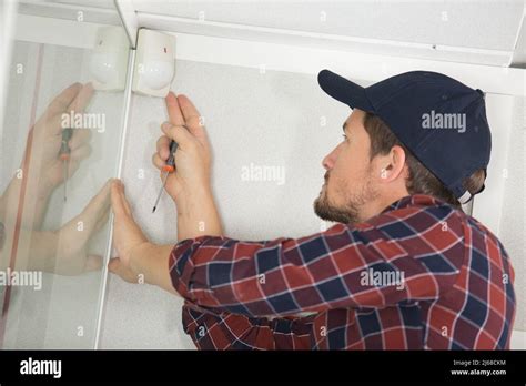 Man Installing Alarm Bell On Wall Stock Photo Alamy
