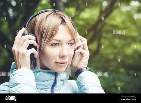 Portrait Of An Attractive Sports Girl Blonde In A Light Running Down
