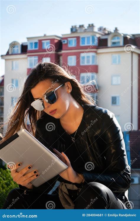 Curious And Stylish Tech Savvy Teenager Engrossed In Digital