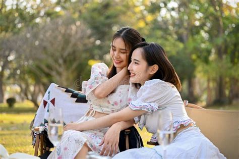 Two Beautiful Asian Female Besties Cuddle Sharing A Special Moment